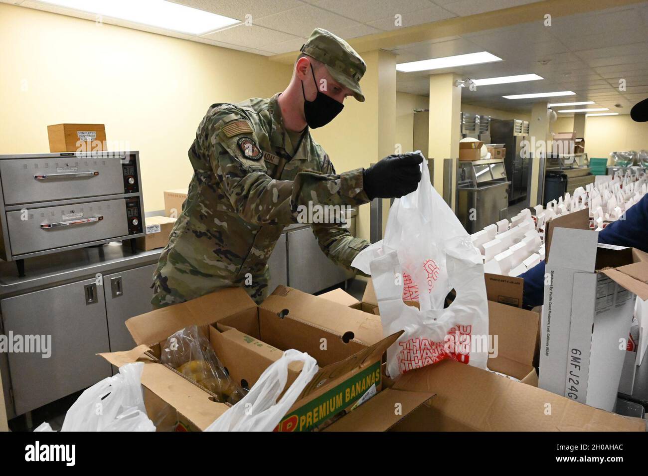 Airman Paul Holaday, of the 119th Services Flight, left, packages ...