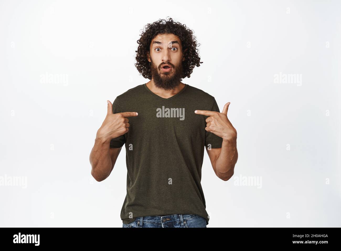 Portrait of young man pointing at himself with surprised reaction ...