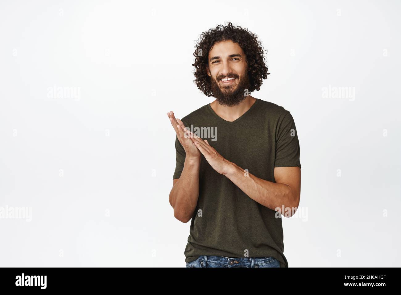 Portrait of handsome smiling man clapping hands, applause you, looking ...