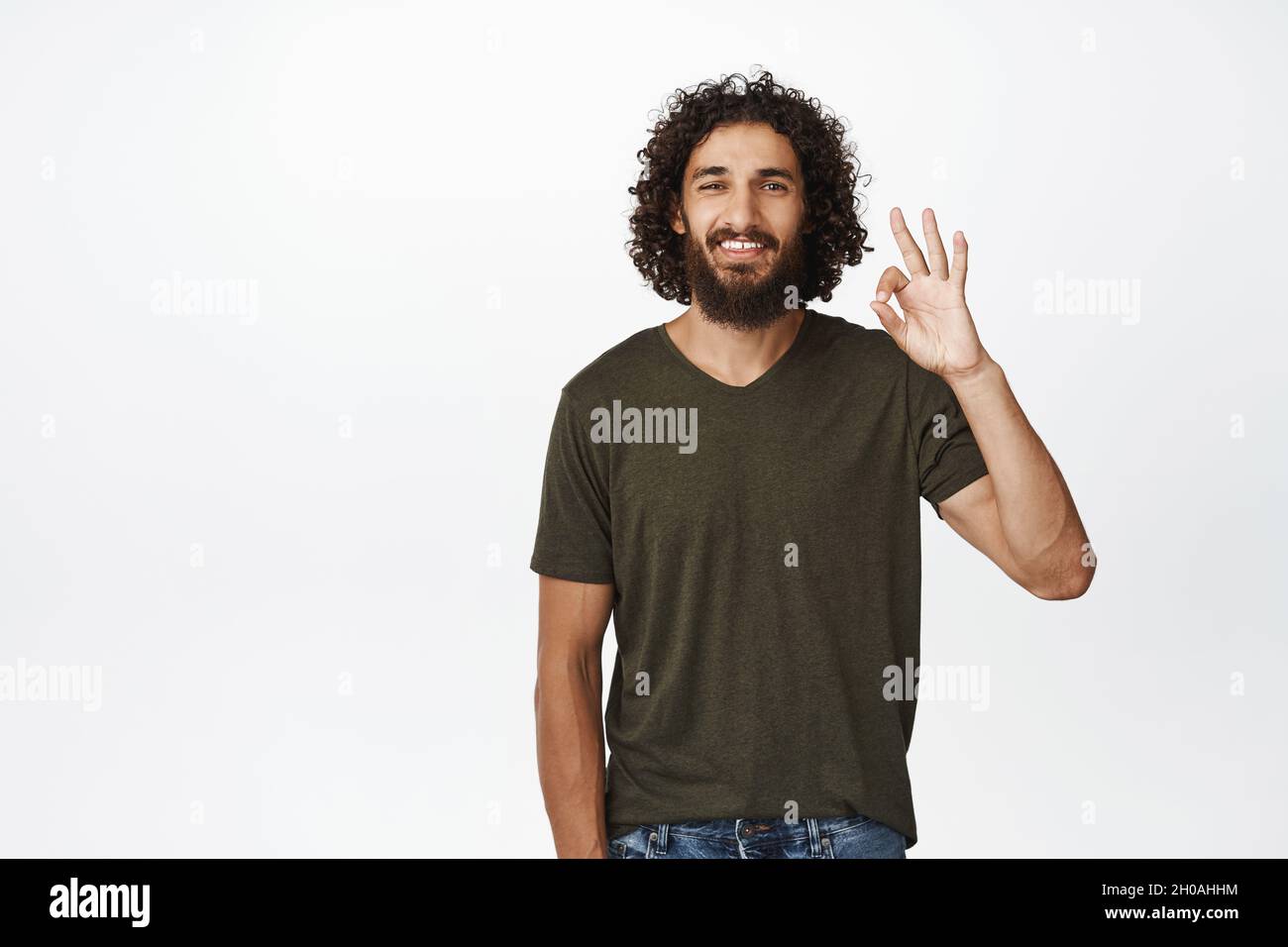 Smiling handsome man showing okay sign, approve and like smth, praise ...