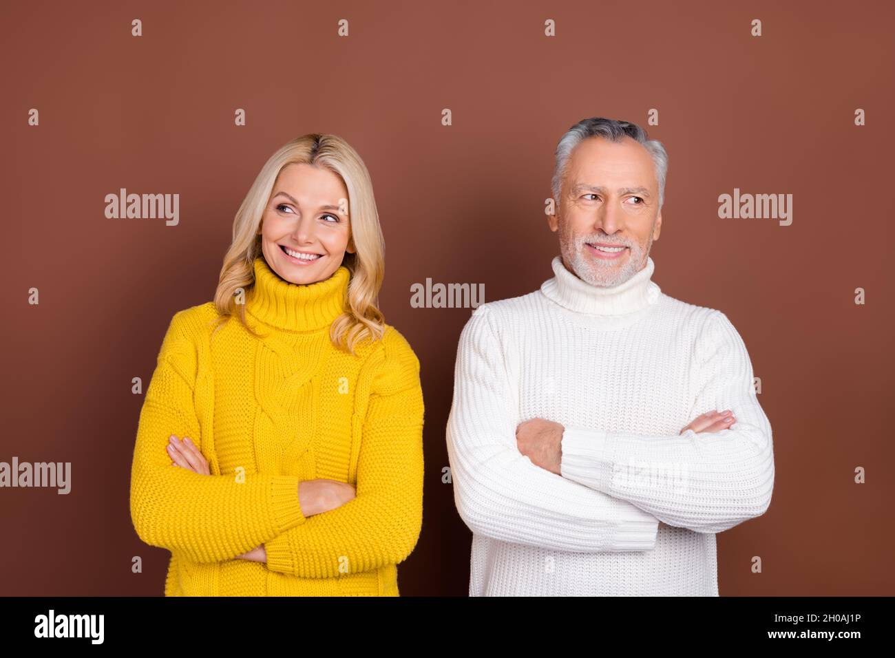 Portrait of two attractive cheerful curious grey-haired people folded ...
