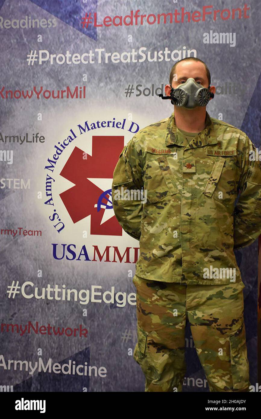 U.S. Air Force Maj. Daniel Williams demonstrates the fit of an N95 ...