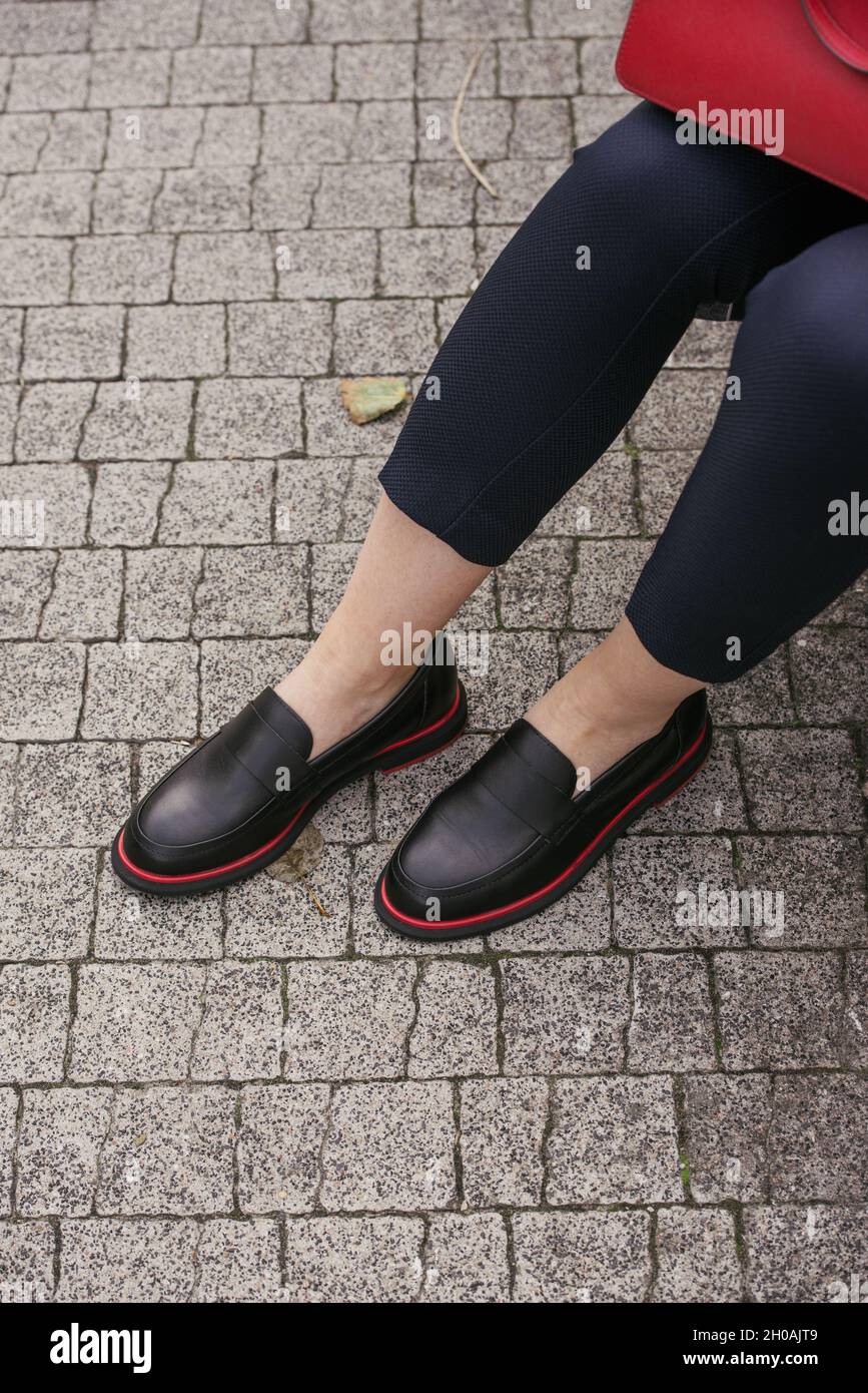 Female fashion concept. Womans legs in a black shoes with red line ...