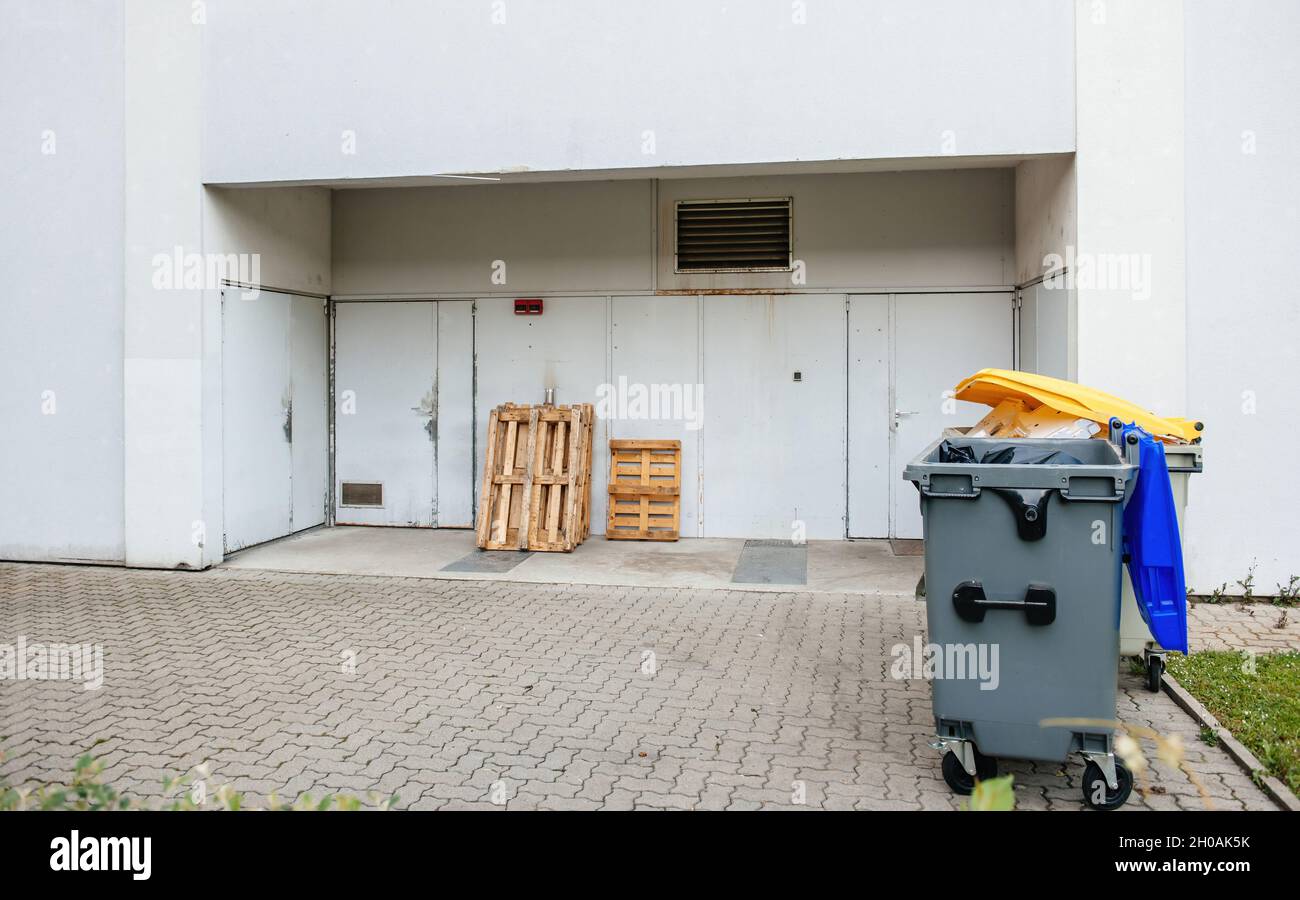 Plastic waste container and wooden pallets on the rear door of a large ...