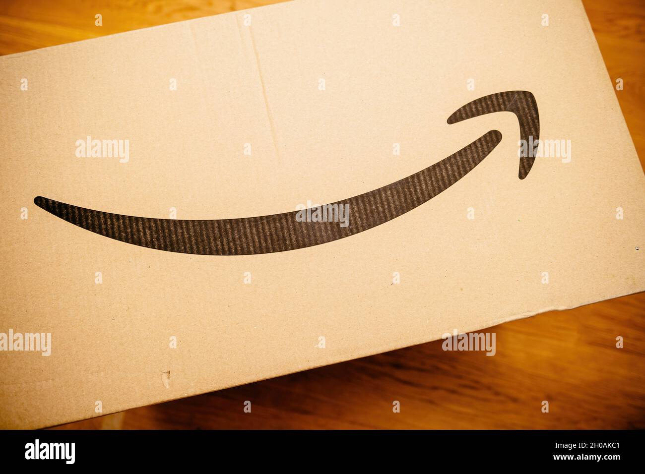 Amazon prime cardboard box parcel on the wooden floor Stock Photo - Alamy