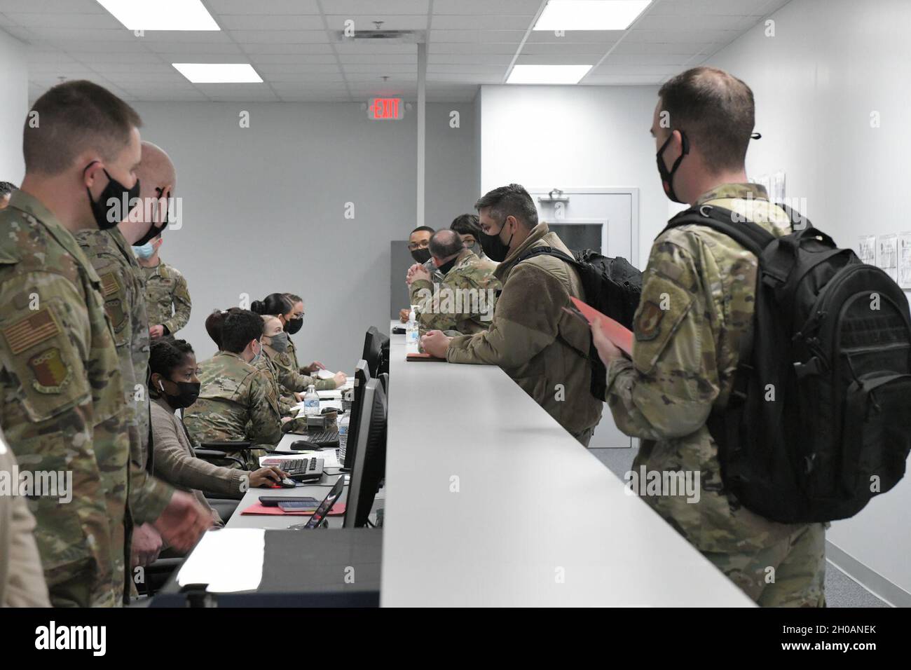 Airmen proceed along a simulated pre-deployment processing line during ...