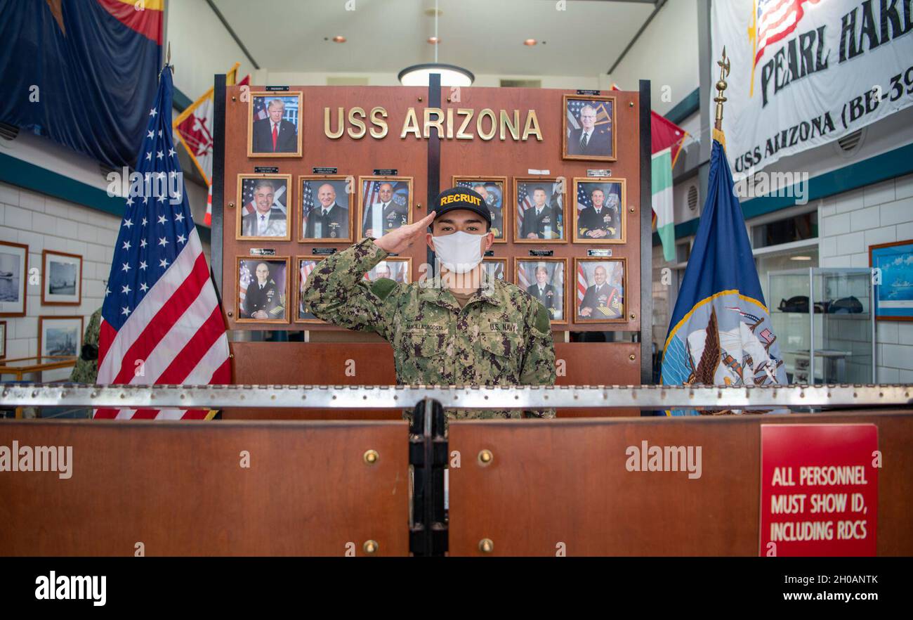 A recruit renders a salute while standing watch inside the USS Arizona ...