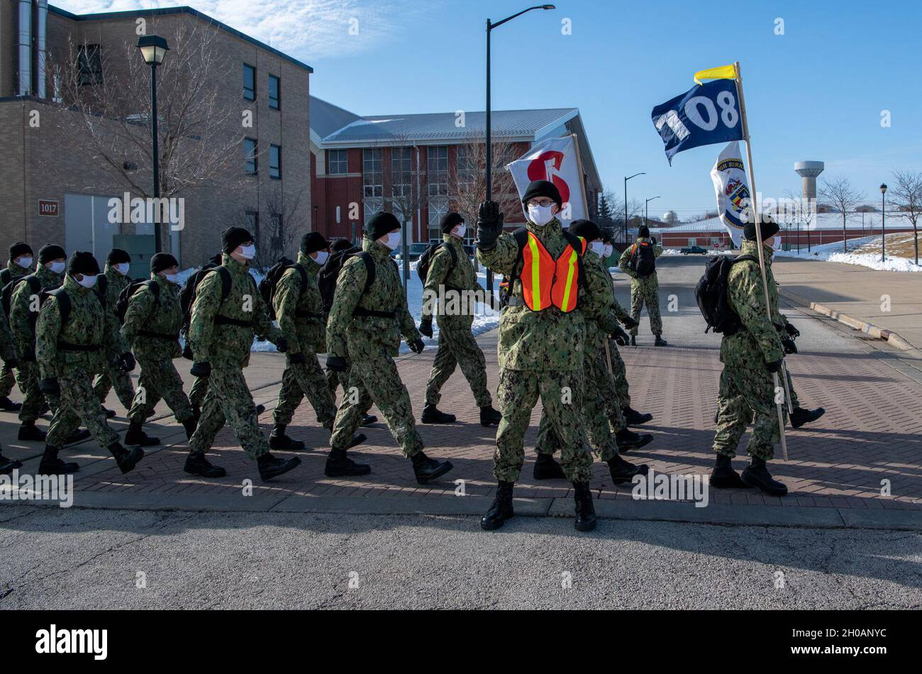 A recruit road guard stops traffic as their division marches in ...