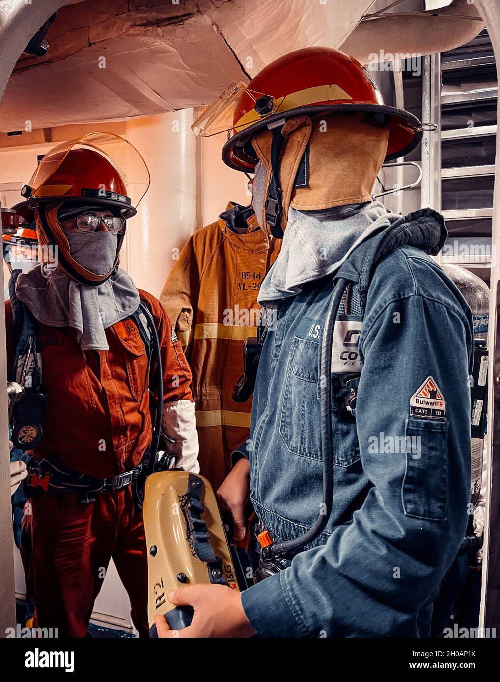 Damage Controlman 3rd Class (First Name) Olea, right, trains Sailors ...