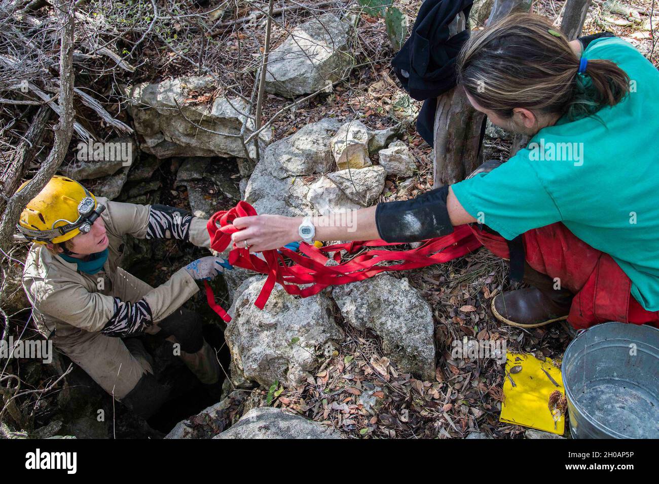 Krista McDermid hands Lucas Pustka safety equipment before he crawls ...