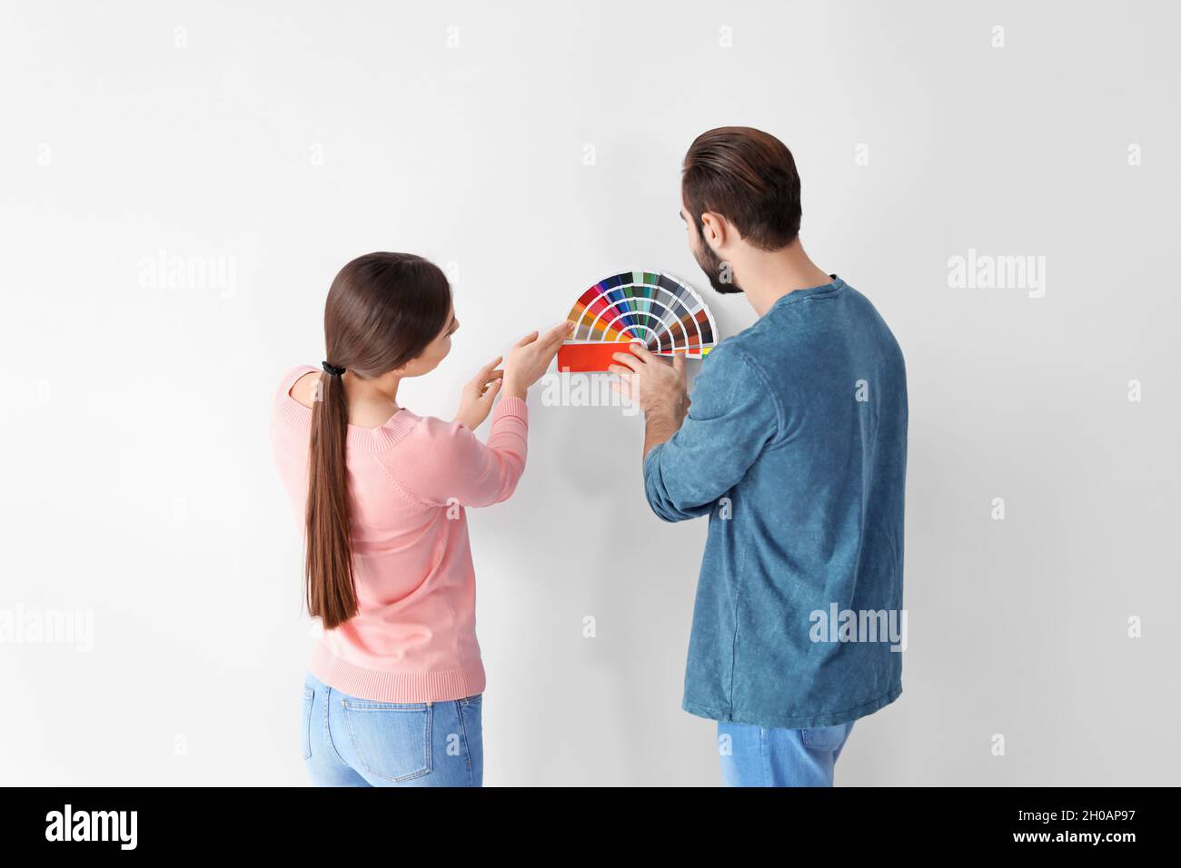 Young couple with color palette on white background Stock Photo - Alamy