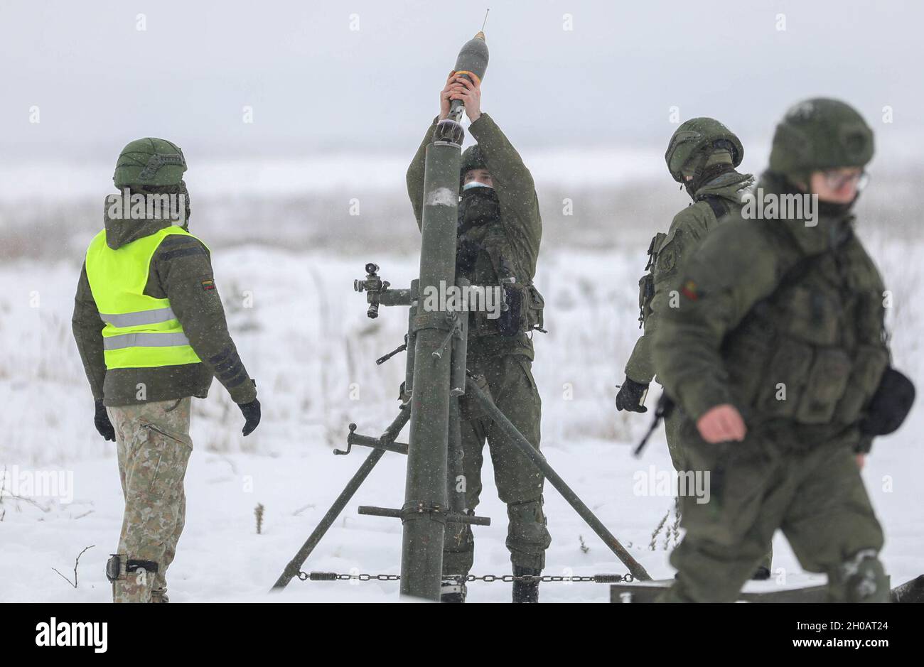 Lithuanian mortar men demonstrate the firing sequence of a mortar ...