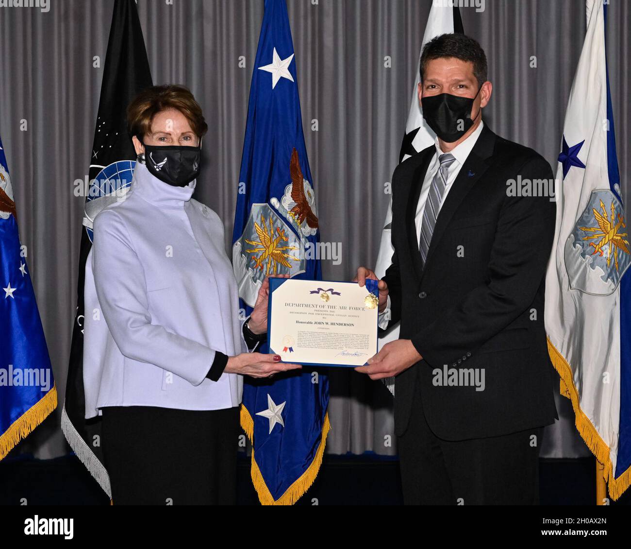 Secretary of the Air Force Barbara M. Barrett poses with John Henderson ...