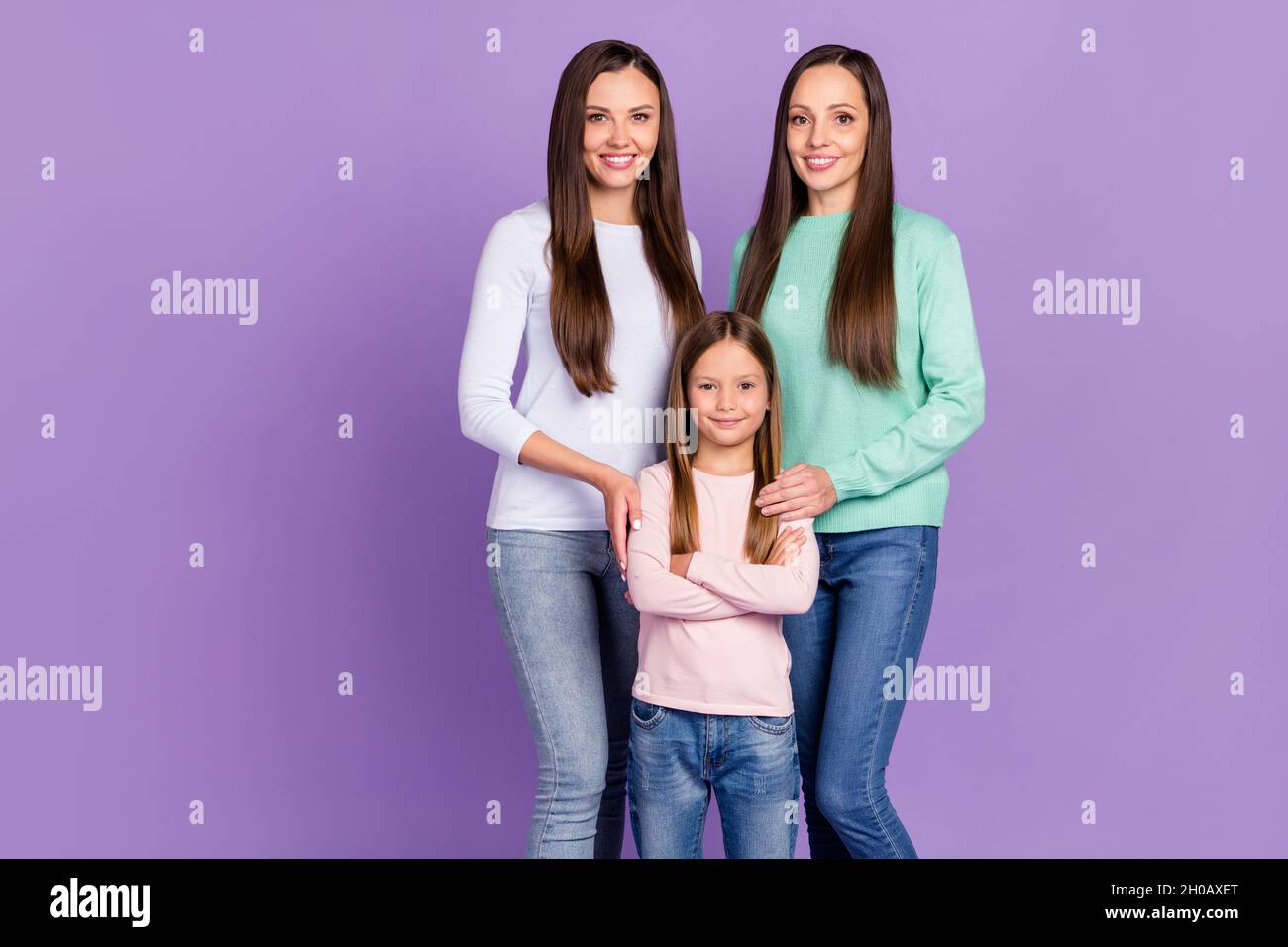 Portrait of three attractive cheerful careful girls hugging isolated ...