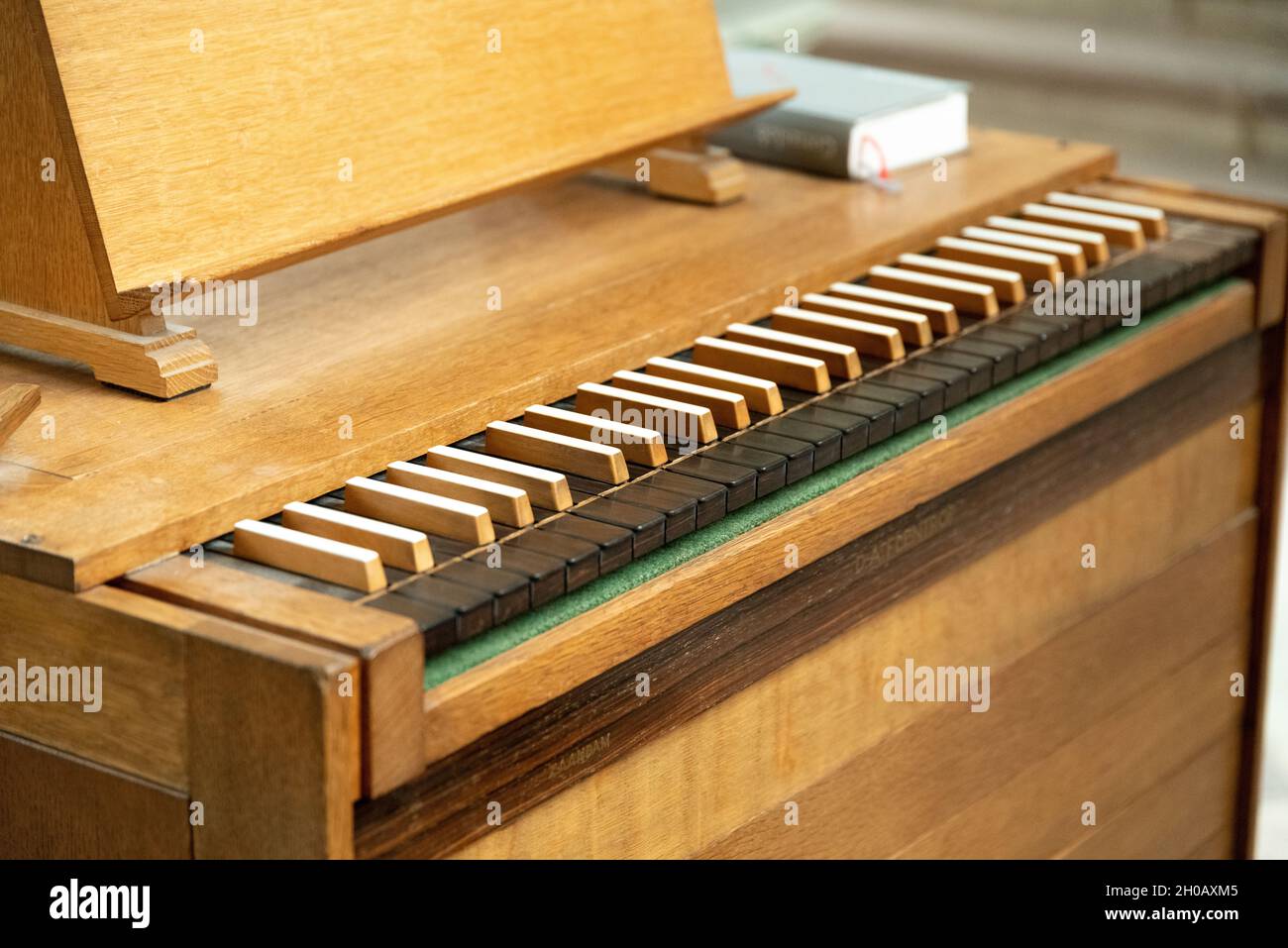Wooden organ with black keys and white half keys with a wooden music ...