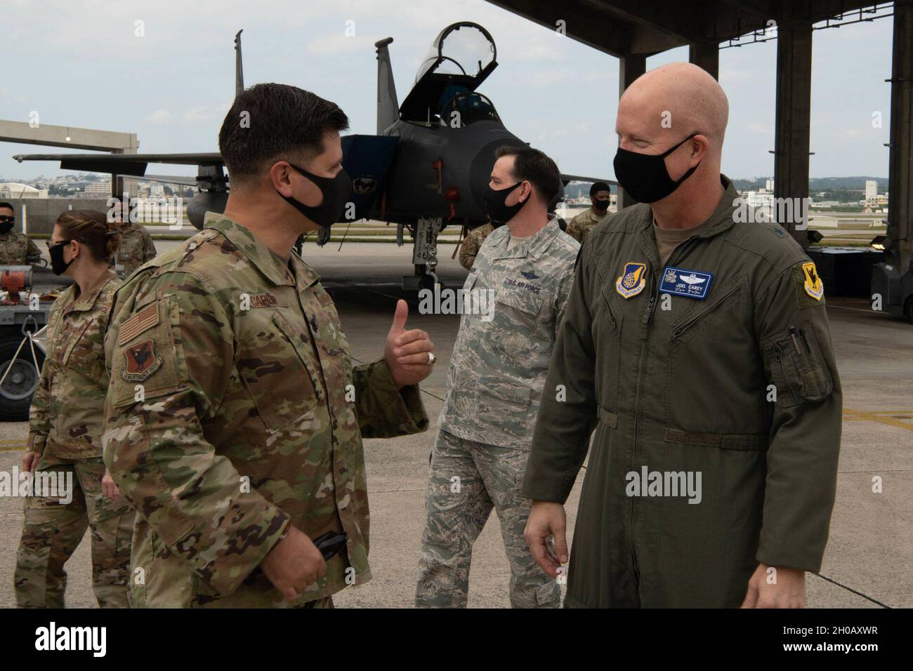 Brig. Gen. Joel L. Carey, commander of the 18th Wing, talks with Lt ...