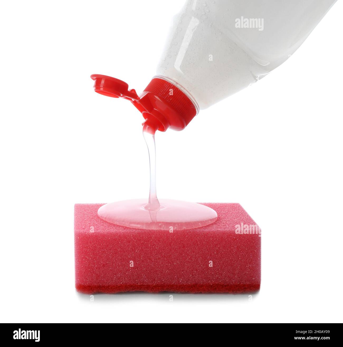 Pouring cleaning product for dish washing onto sponge on white ...