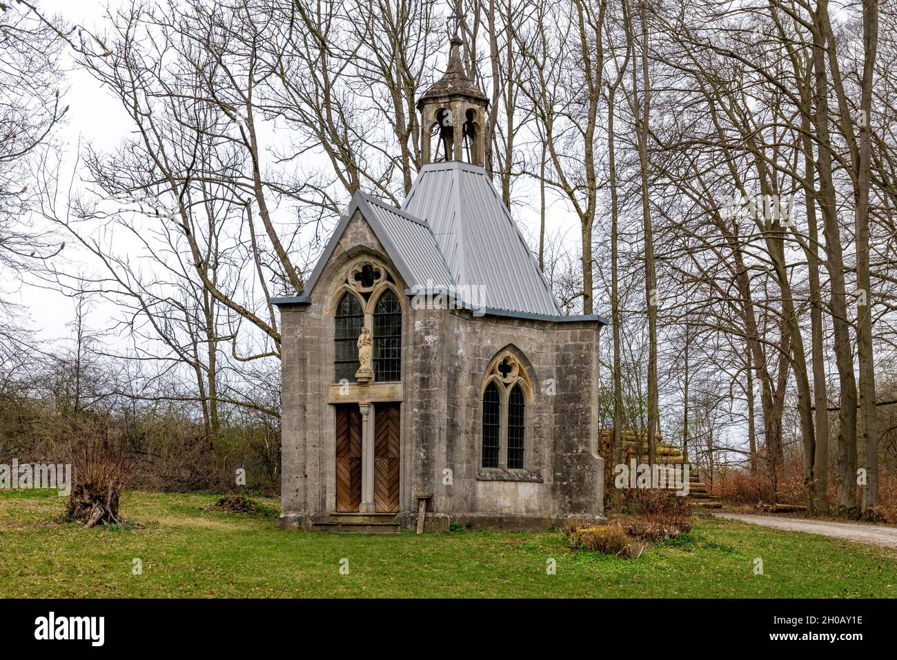 Old gray chapel in the woods with a space in a meadow for a devotion or ...
