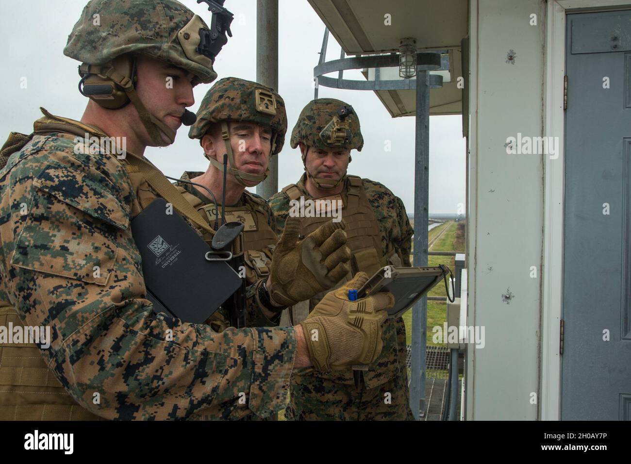 U.S. Marine Corps Sgt. Cecil Decker, left, a joint fires observer with ...