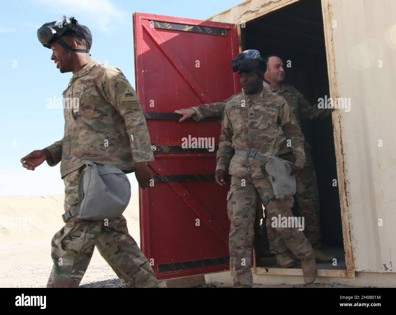 Soldiers with the 40th Brigade Engineer Battalion exit a CS gas chamber ...