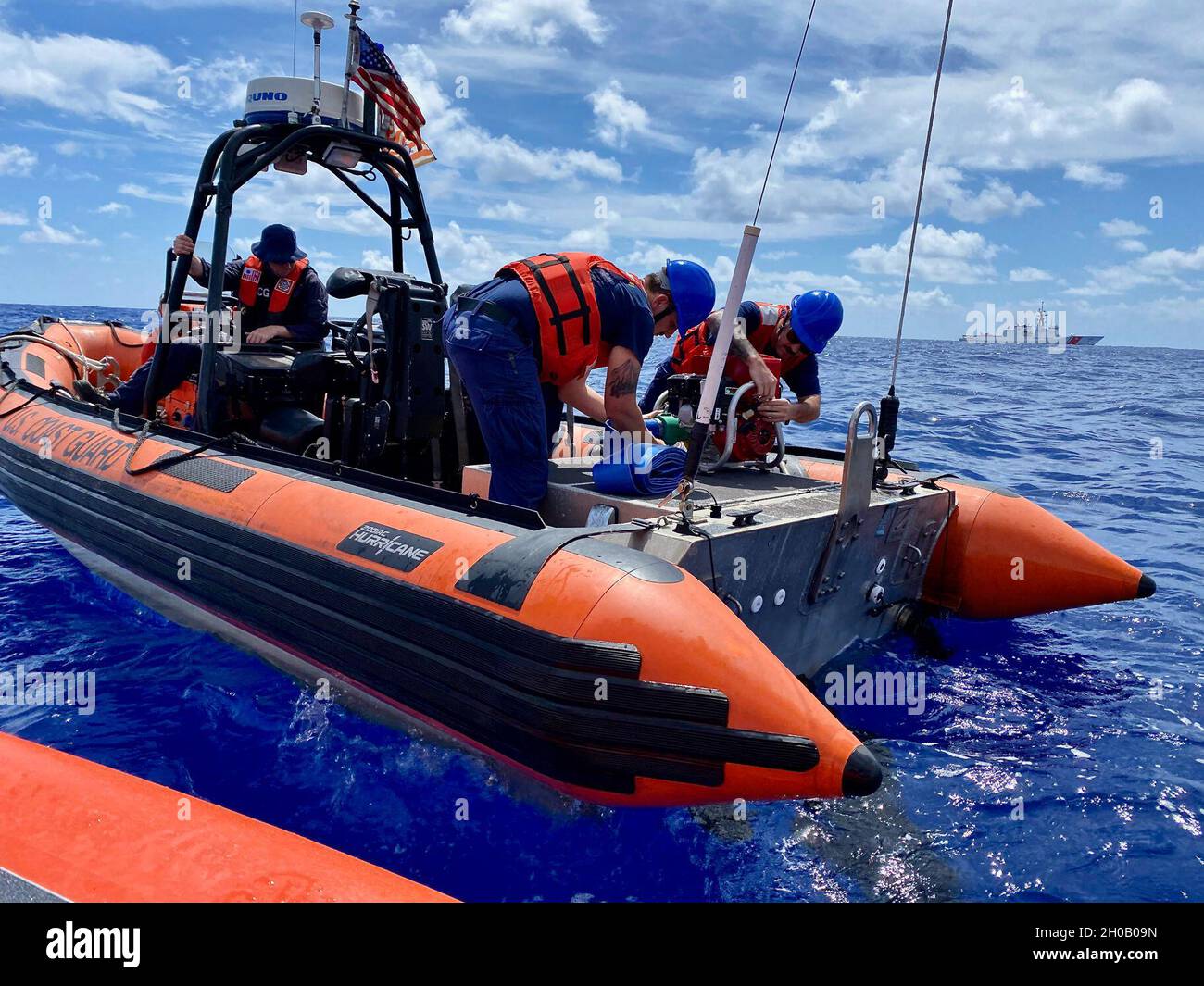 Boat crew members from the USCGC Stone (WMSL 758) set up a dewatering ...