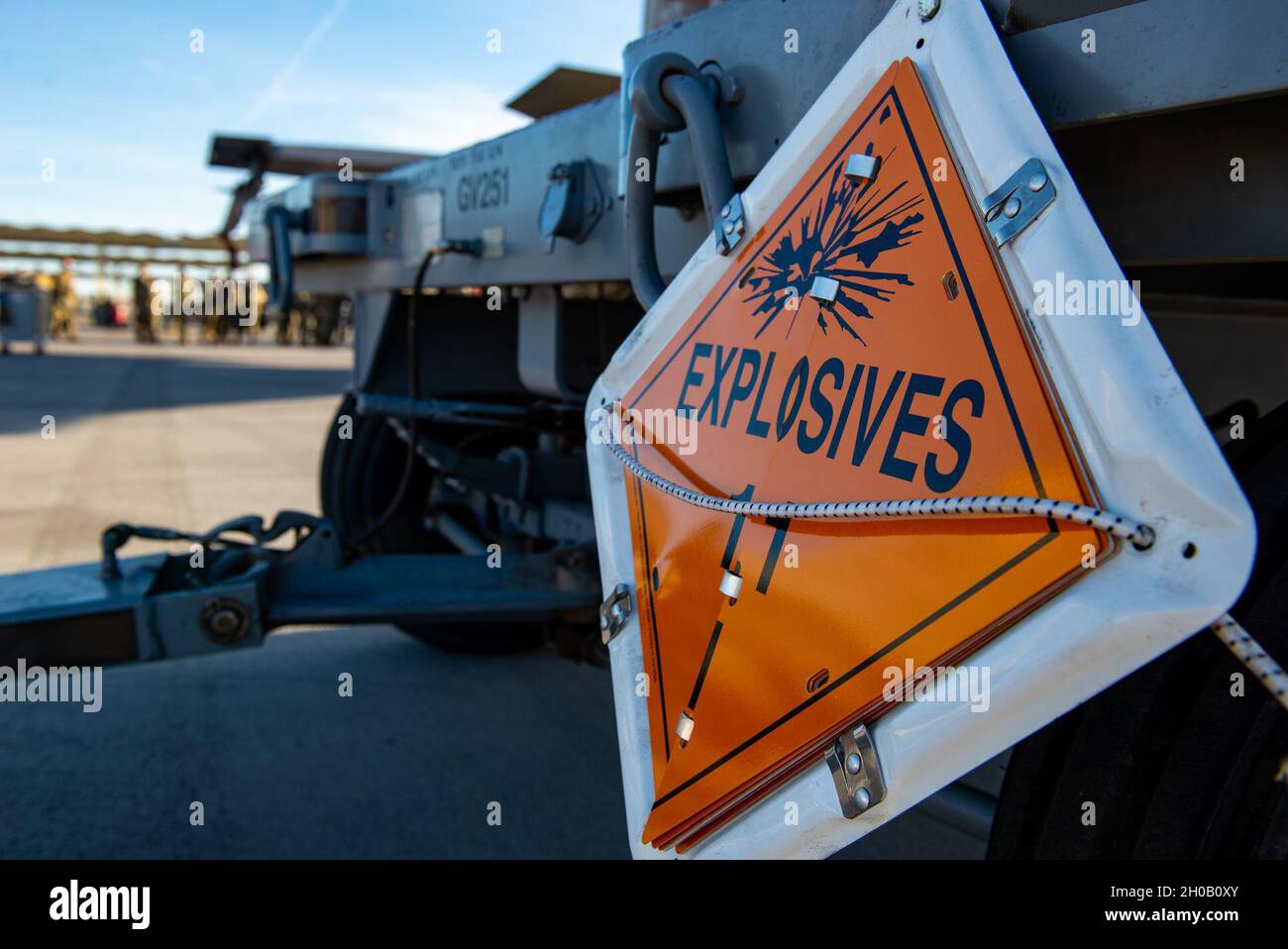 An explosives warning sign attached to a government vehicle is ...