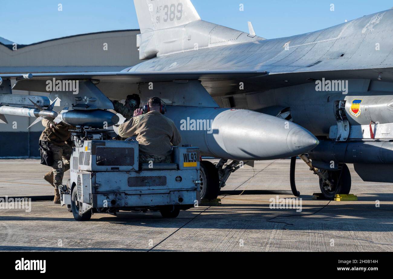 U.S. Airmen assigned to the 20th Maintenance Group weapons flight load ...