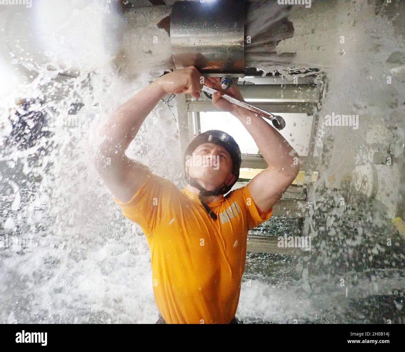 An Officer Candidate School (OCS) class 06-21 student tightens a ...