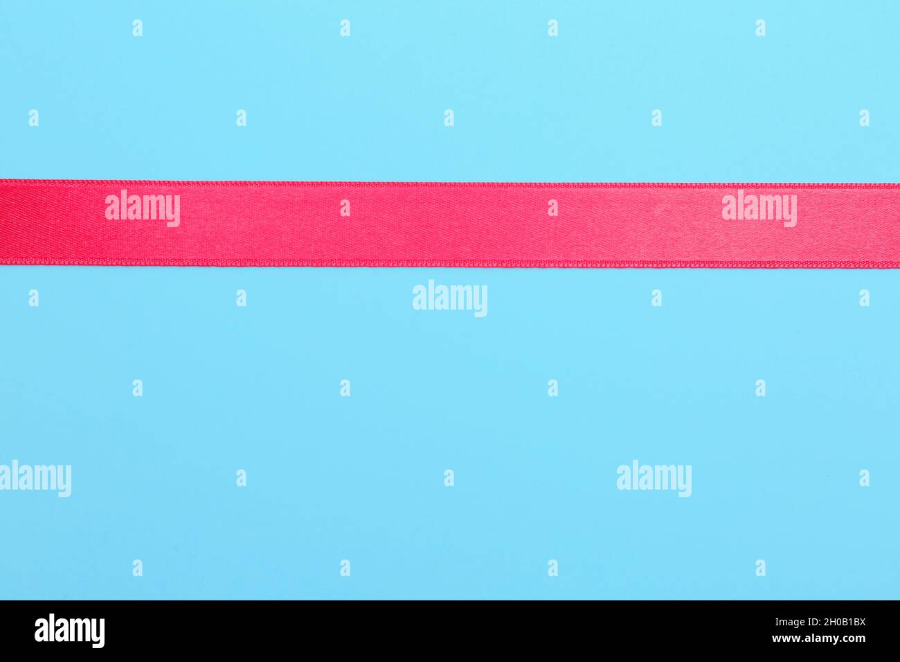 Simple pink ribbon on color background, top view Stock Photo - Alamy