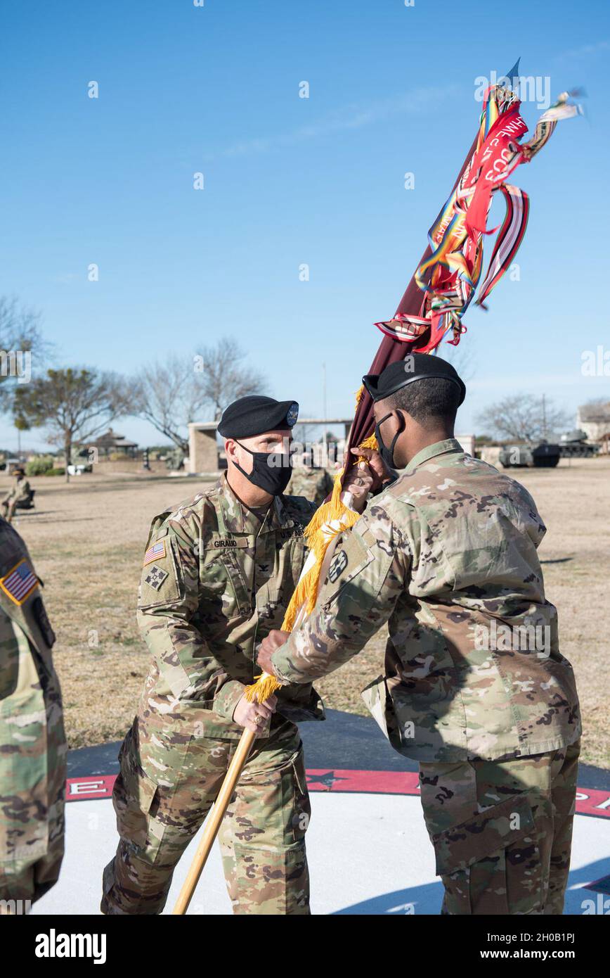 New 1st Med. Bde. Commander, Col. Roger Giraud, hands the guidon to ...