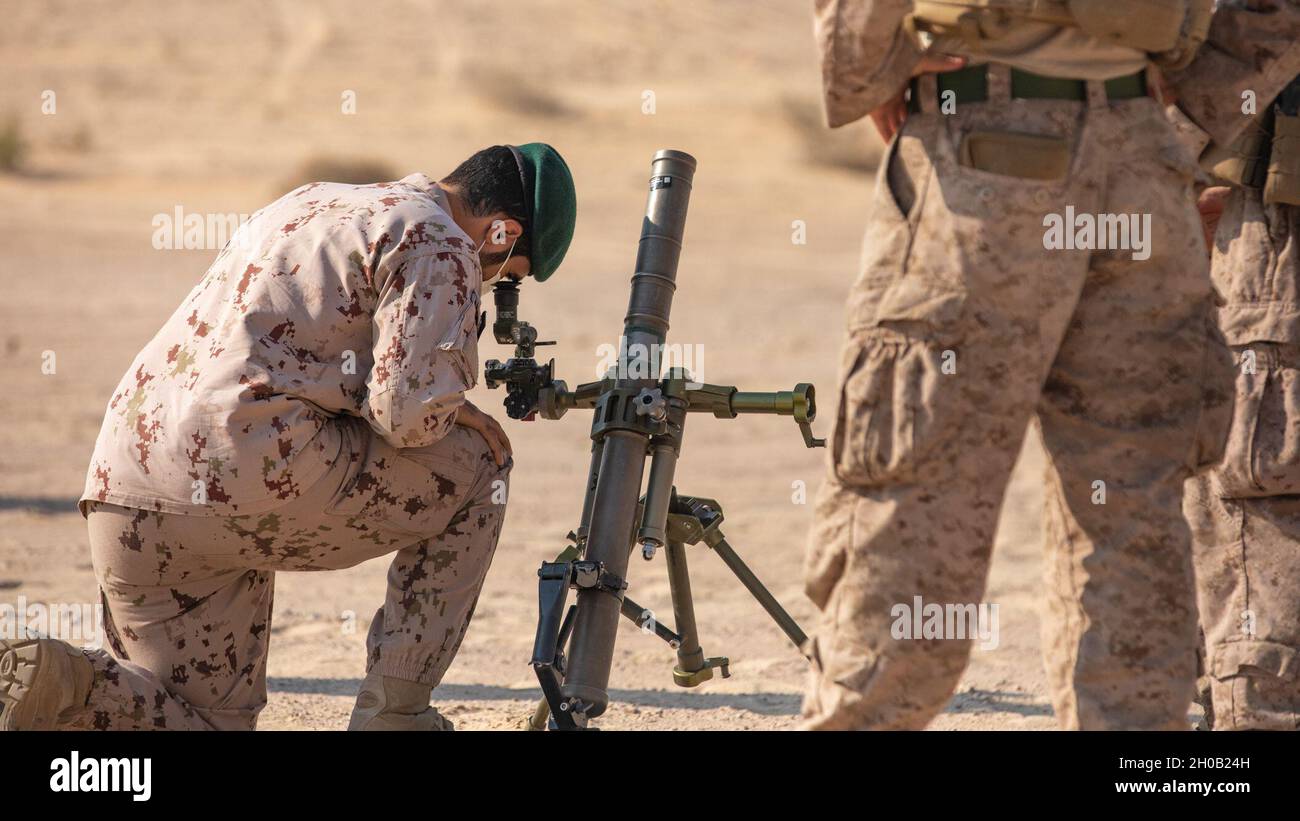 A United Arab Emirate Presidential Guardsman examines a sight on an M224 60 mm mortar system ...