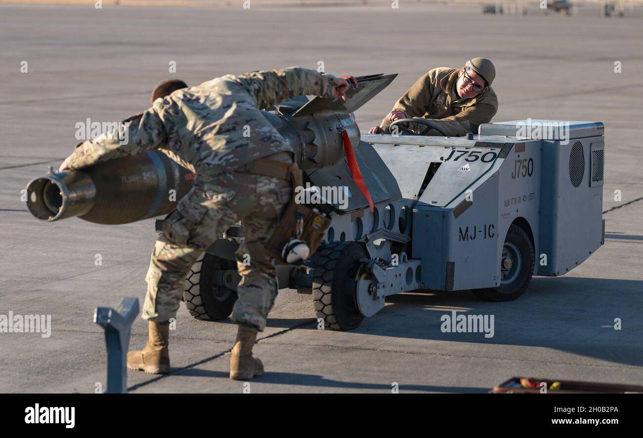 Weapons loaders from the 57th Maintenance Squadron prepare to load a ...