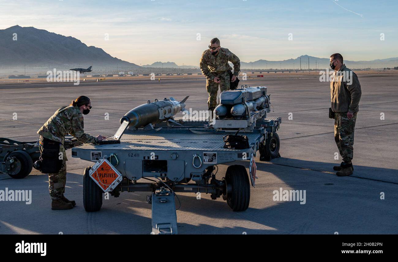 Weapons loaders from the 57th Maintenance Squadron prepare to load ...