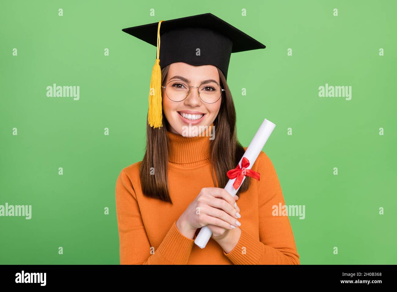 Portrait of attractive cheerful girl holding scroll paper finish get ...