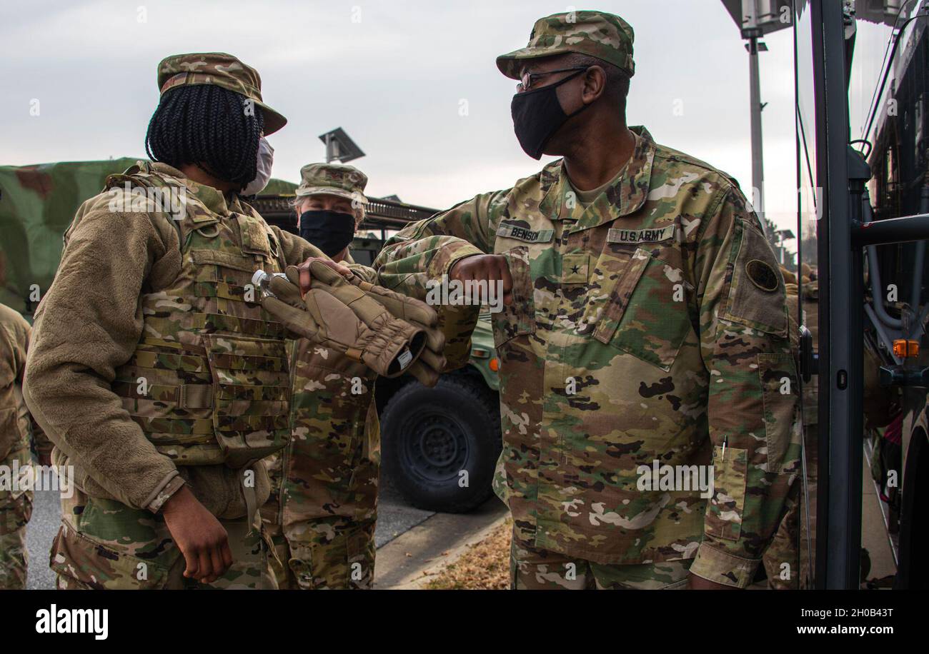 Brig Gen. James Benson addresses Airmen individually as they depart in ...