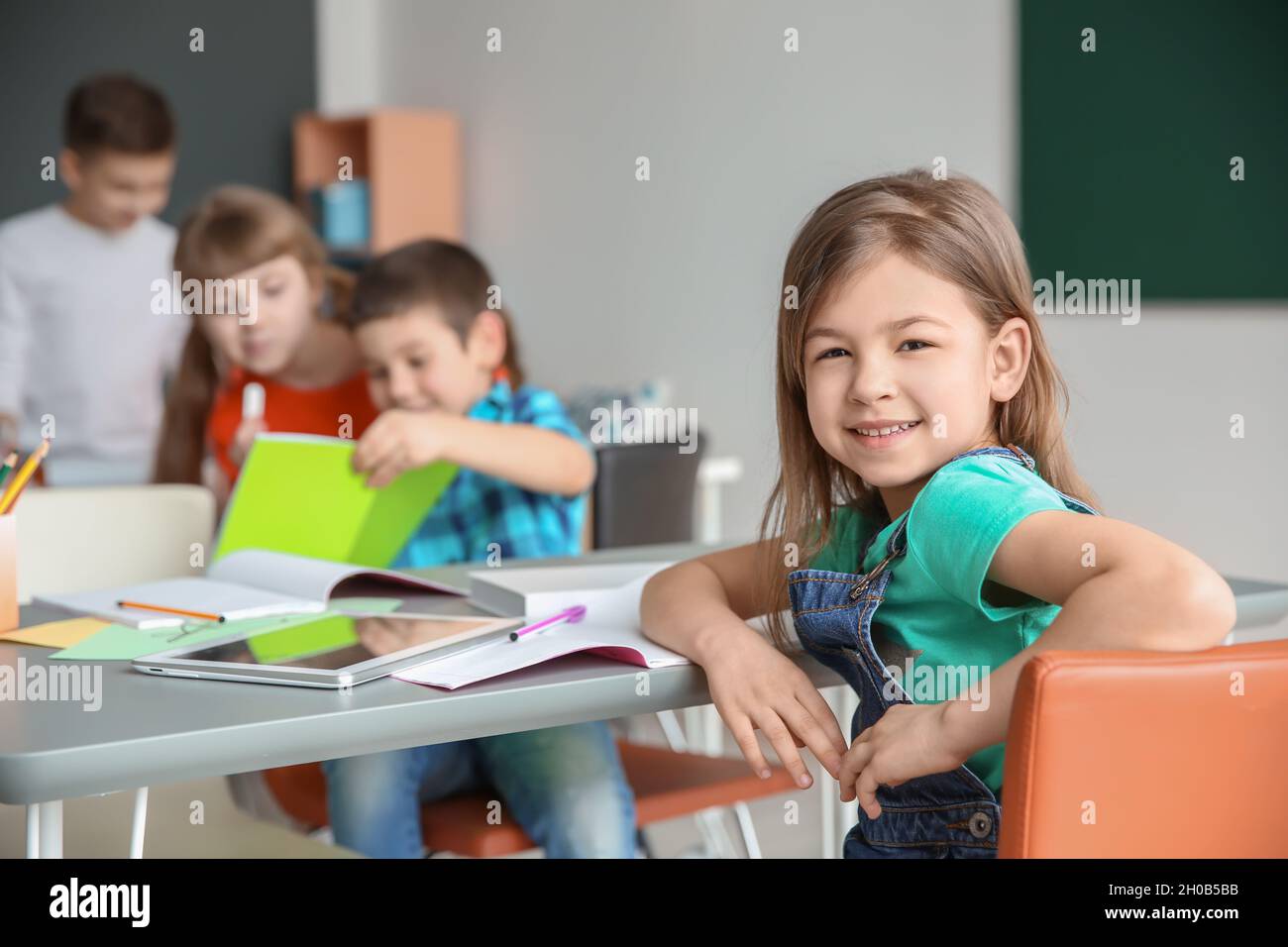 Cute little girl in classroom at school Stock Photo - Alamy