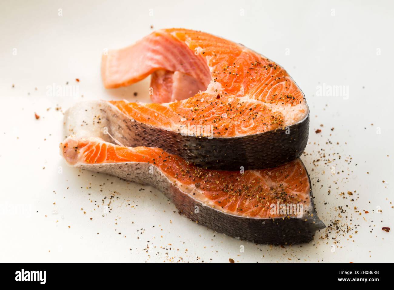 Raw trout fillet with spices on white background Stock Photo - Alamy