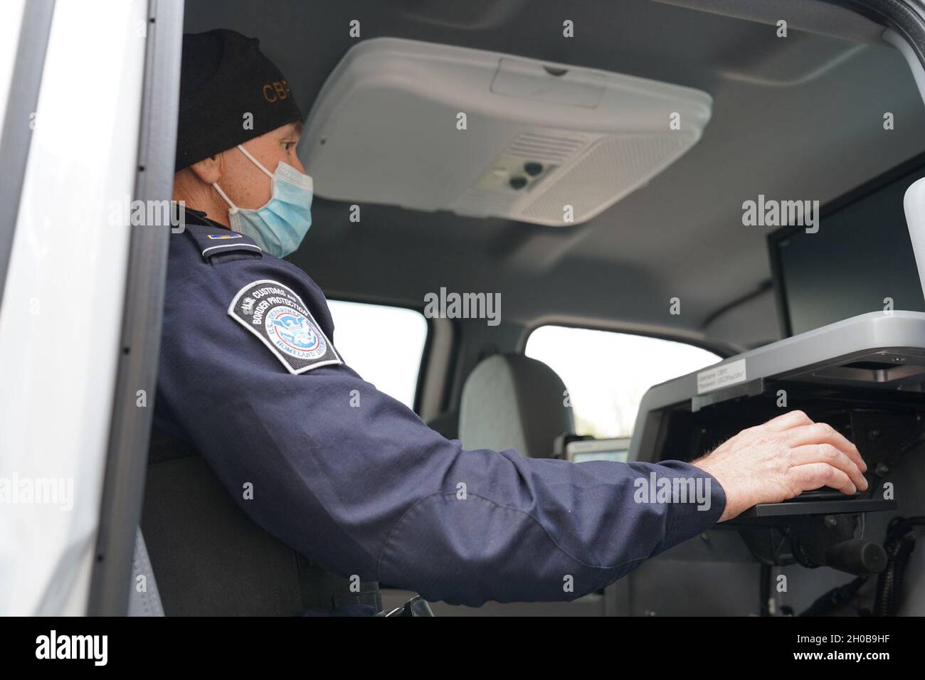 A U.S. Customs and Border Protection officer operates scanning ...
