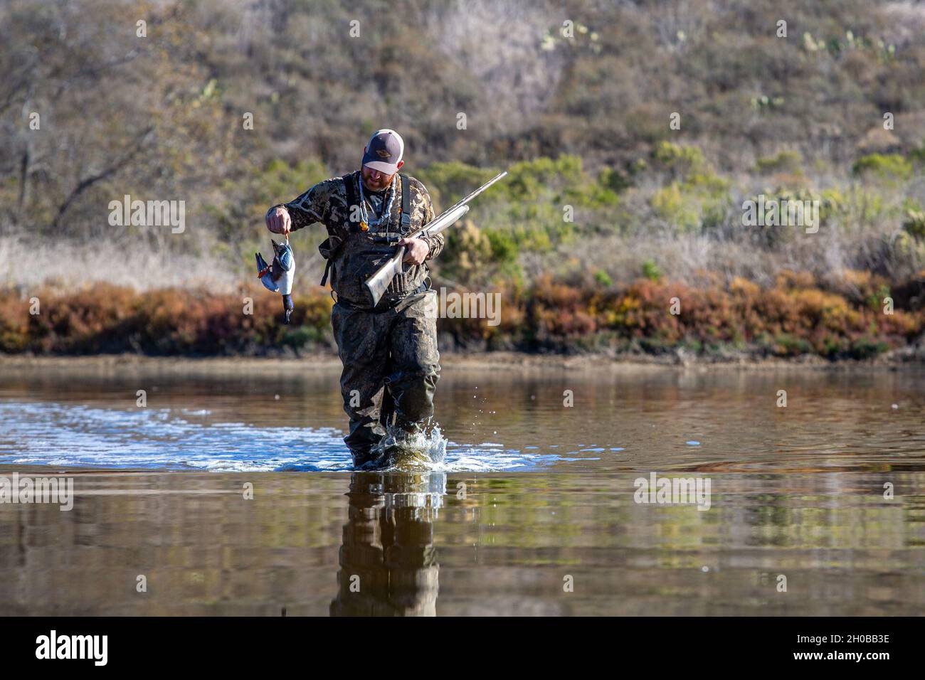 Eric Strand, a hunter with Born and Raised Outdoors, walks through ...