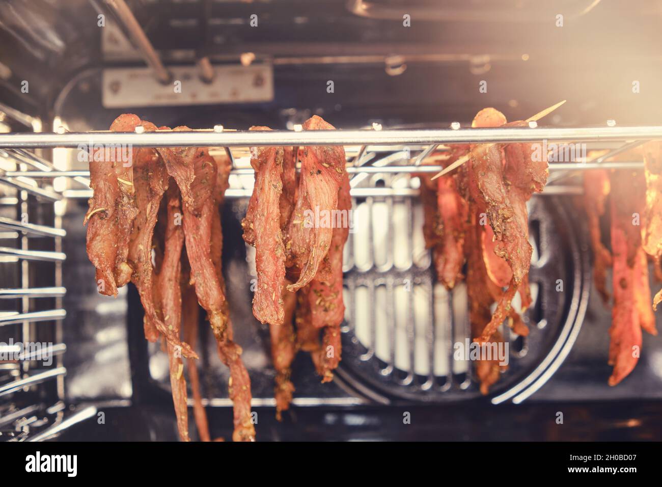 Chicken meat is drying on the grill in the oven in the home kitchen ...