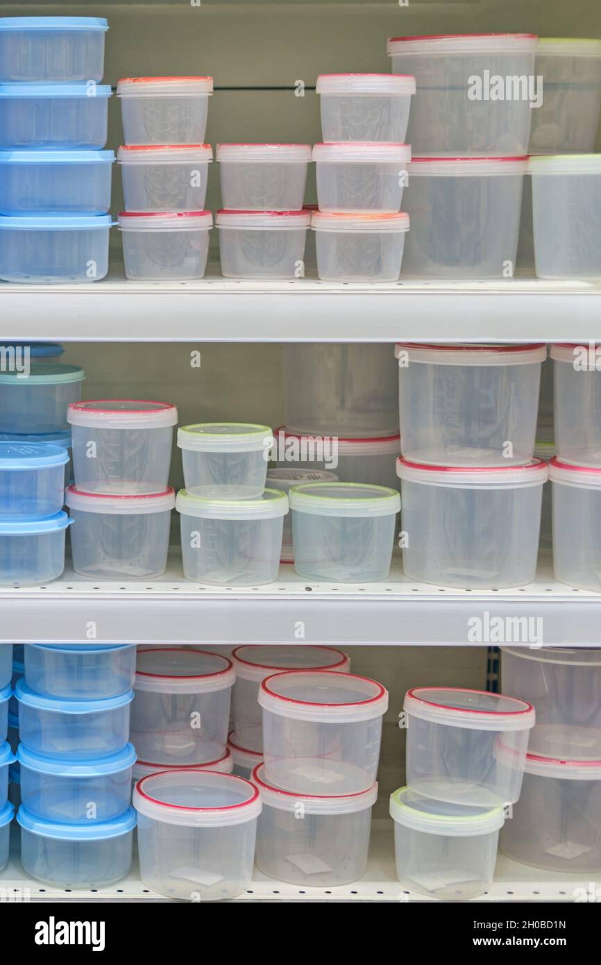 Plastic dishes and containers are sold on the shelves in the store ...
