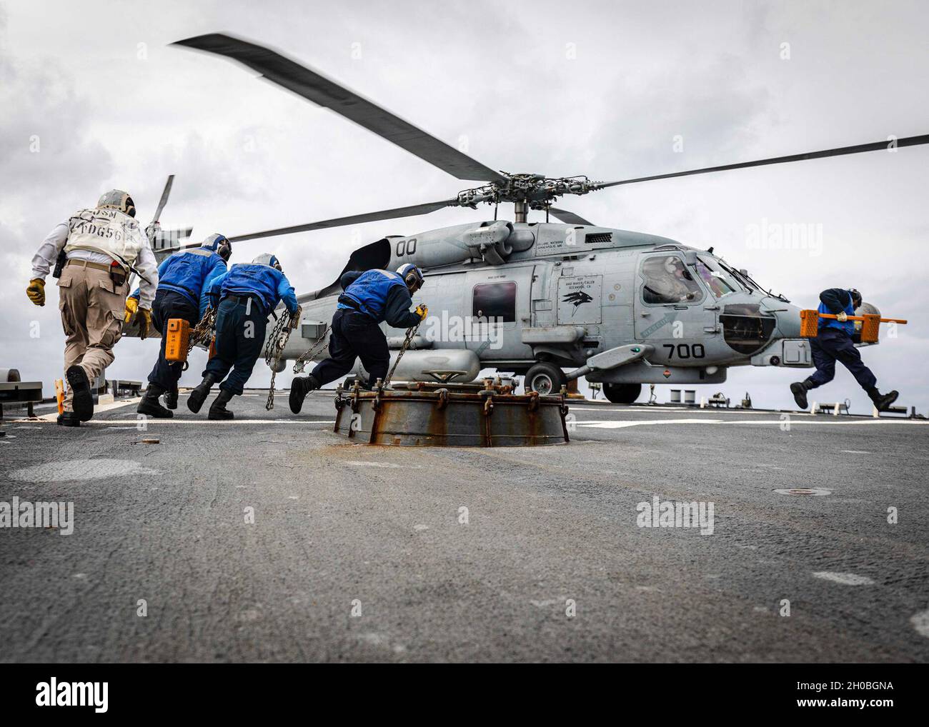 Sailors prepare to ground an MH-60R Sea Hawk, assigned to the “Wolf ...