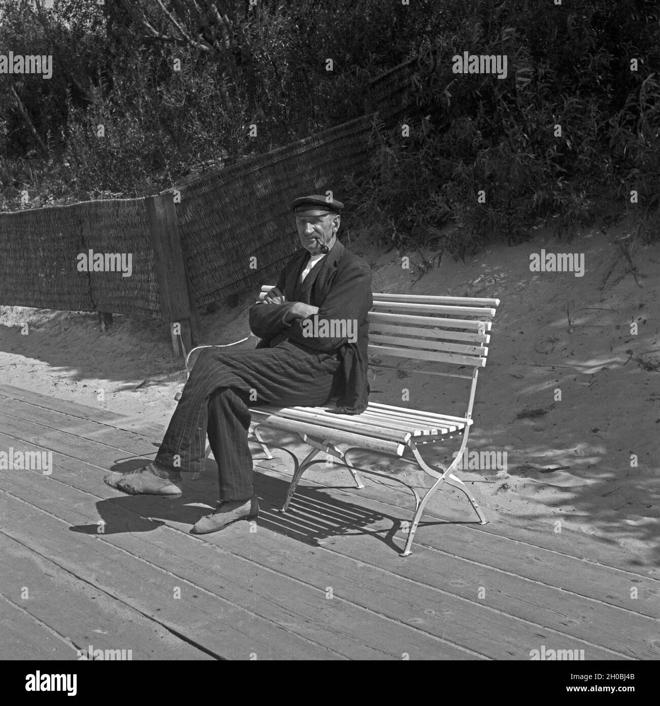 Ein alter Fischer sitzt auf einer Bank bei Pillkallen an der Kurischen ...