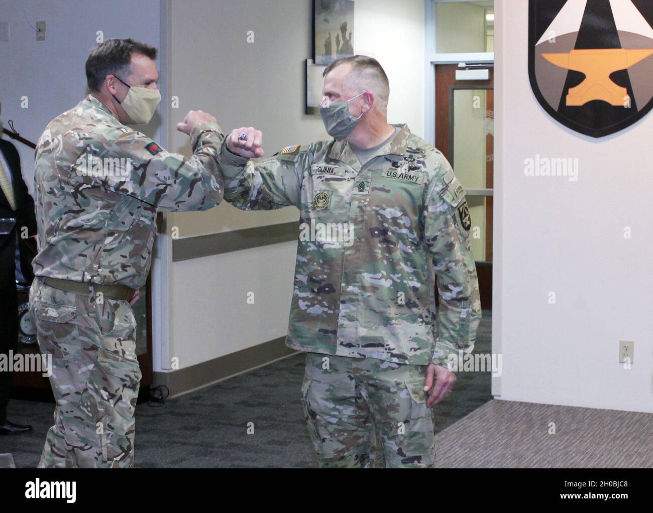 Command Sgt. Maj. Christopher Gunn (right) is greeted by Lt. Col. Kevin ...