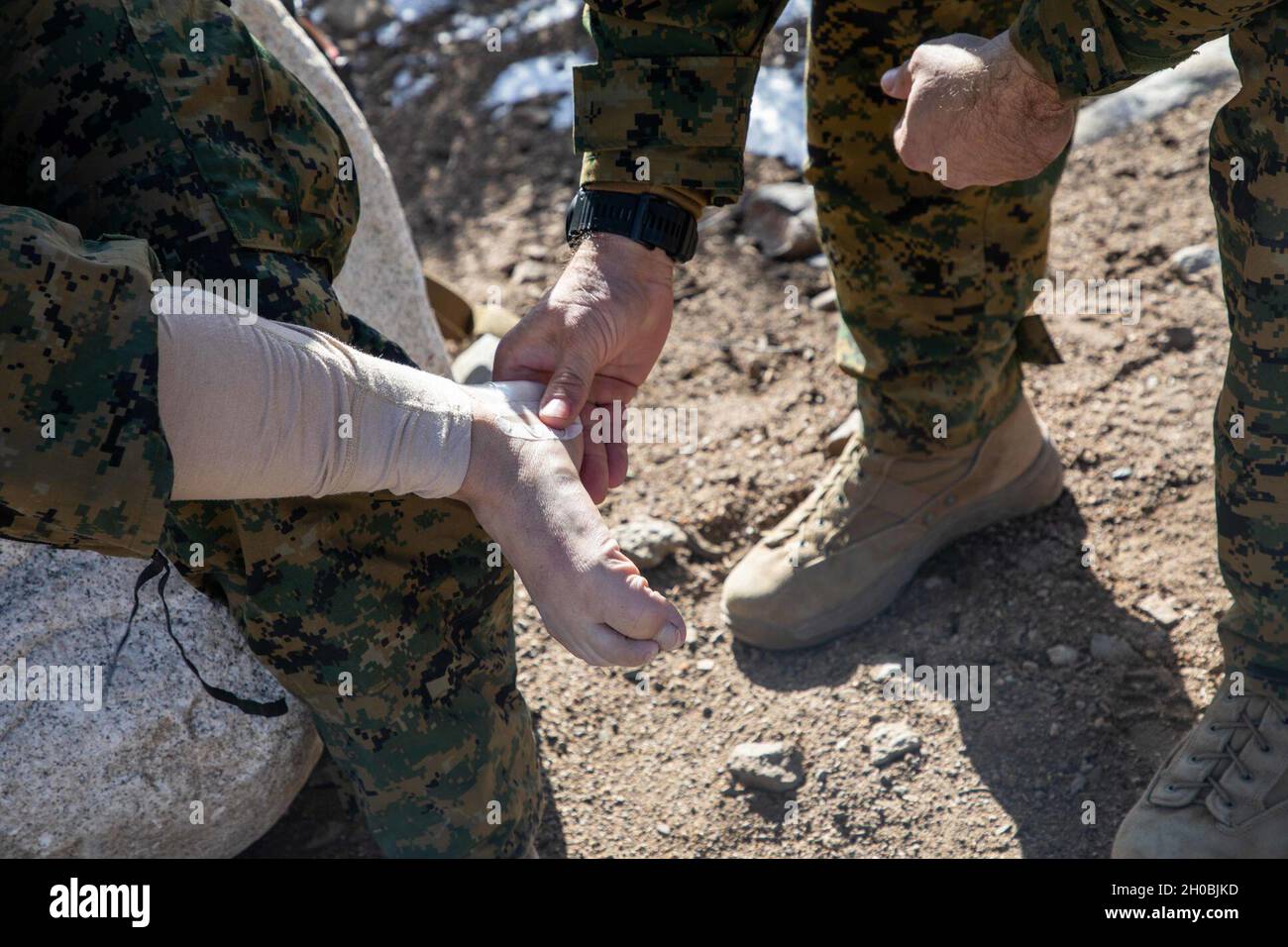 U.S. Navy Hospital Corpsman First Class Matthew Werth applies a ...