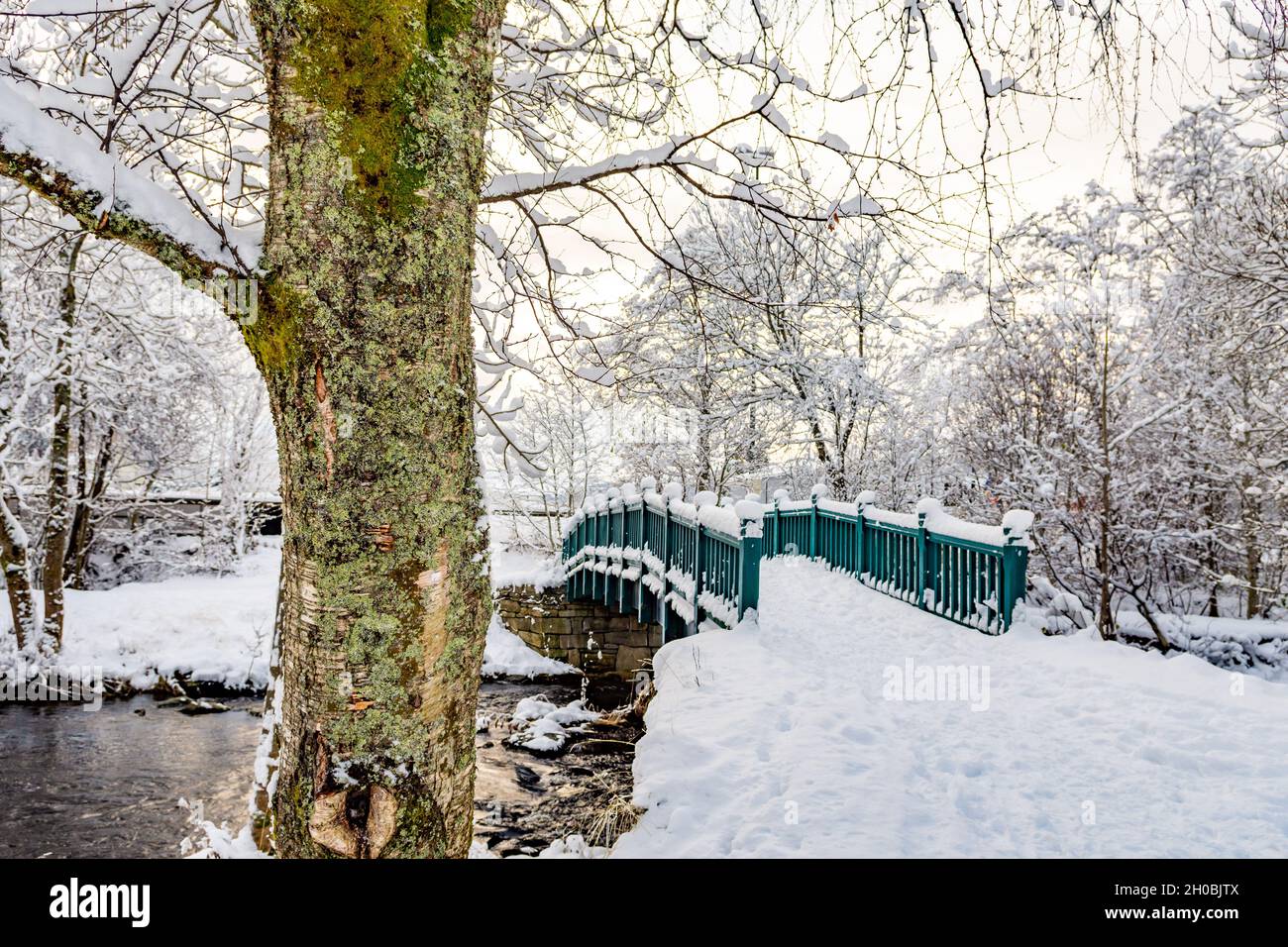 Beautiful scene with a snow-covered bridge in the Volda village, Norway ...