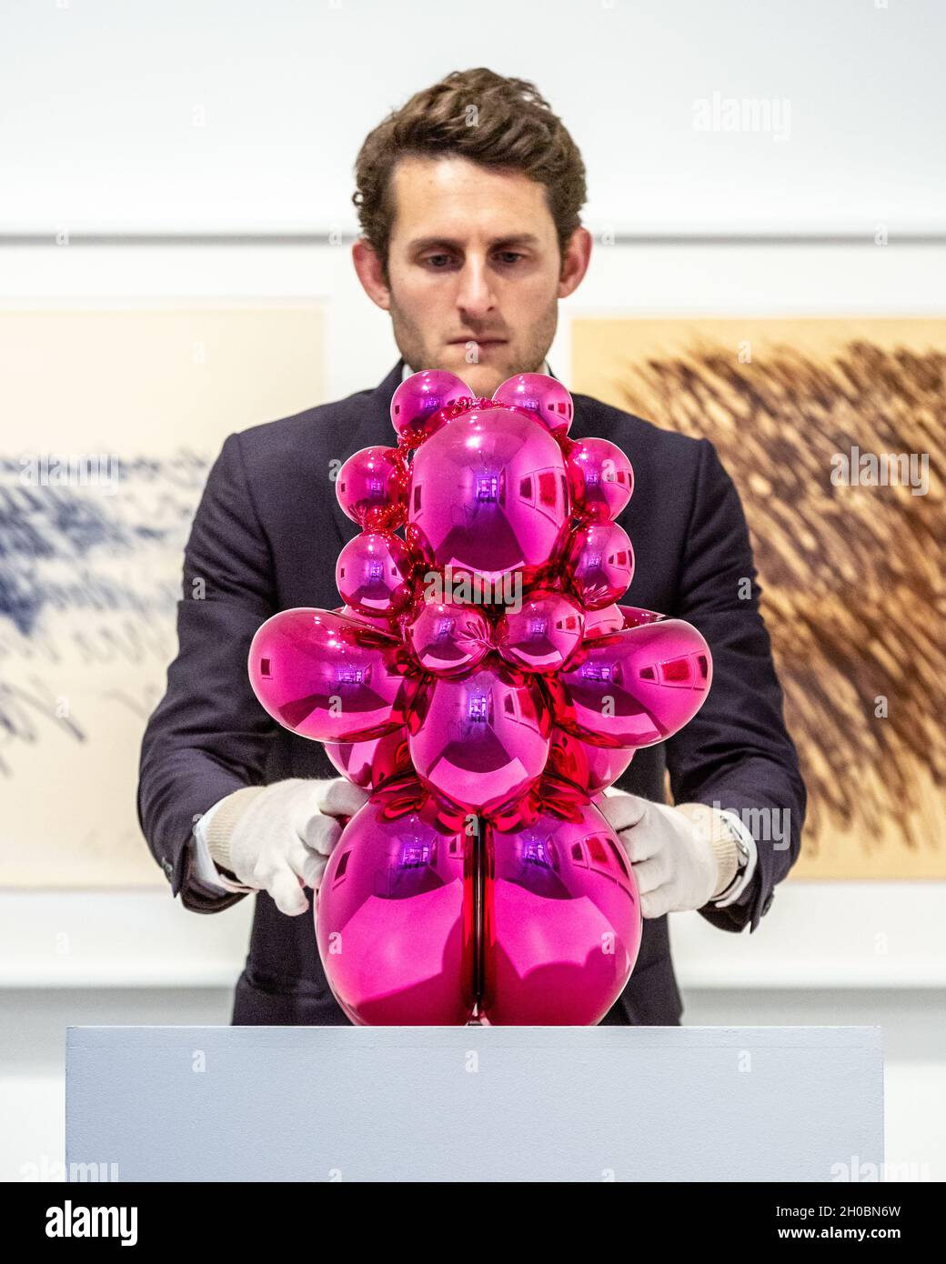 London, UK. 12th Oct, 2021. Gallery staff with 'Dom Perignon Balloon ...