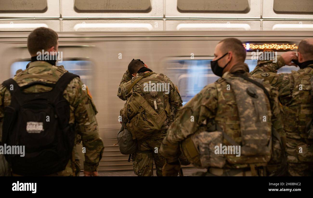 U.S. Soldiers with the North Carolina National Guard wait to board a ...