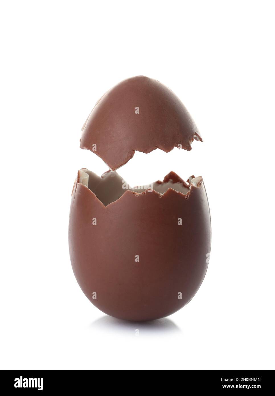 Cracked chocolate Easter egg on white background Stock Photo - Alamy
