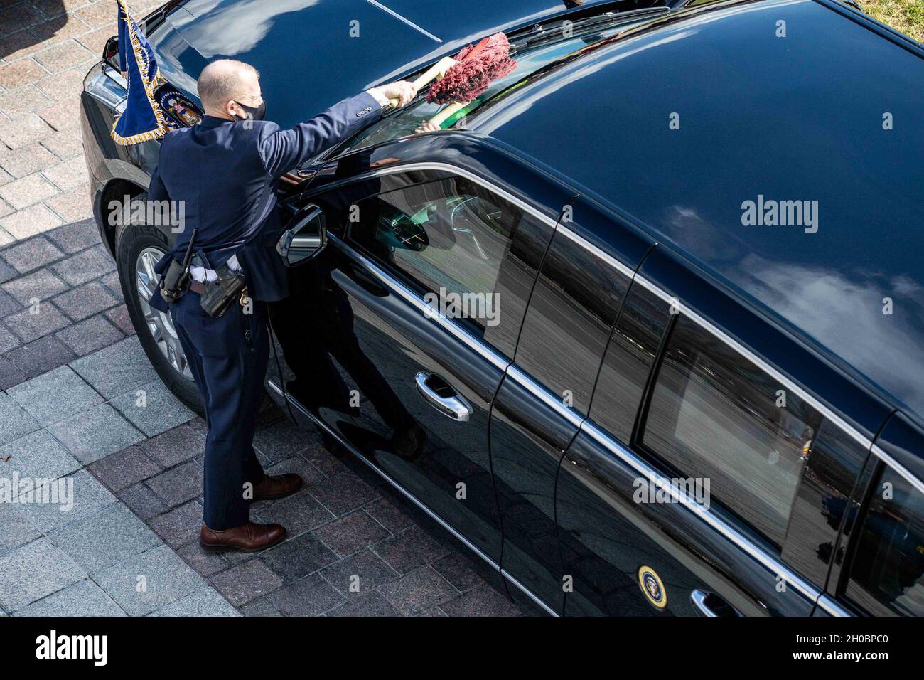A Secret Service Agent prepares the Presidential Motorcade for movement ...